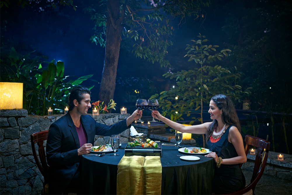 A romantic candle light dinner by the pool side at Club Mahindra Resorts